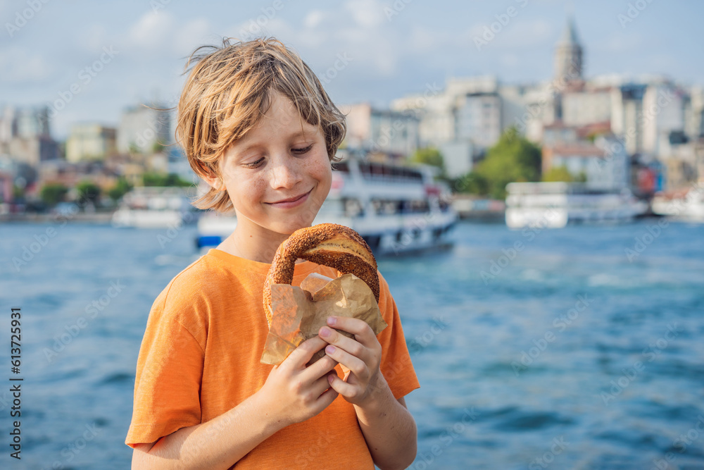 Boy in Istanbul having breakfast with Simit and a glass of Turkish tea ...