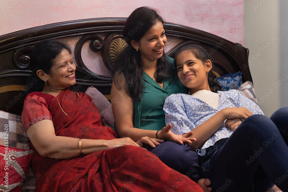 Multi generation Indian family sitting on bed in bedroom Stock Photo ...