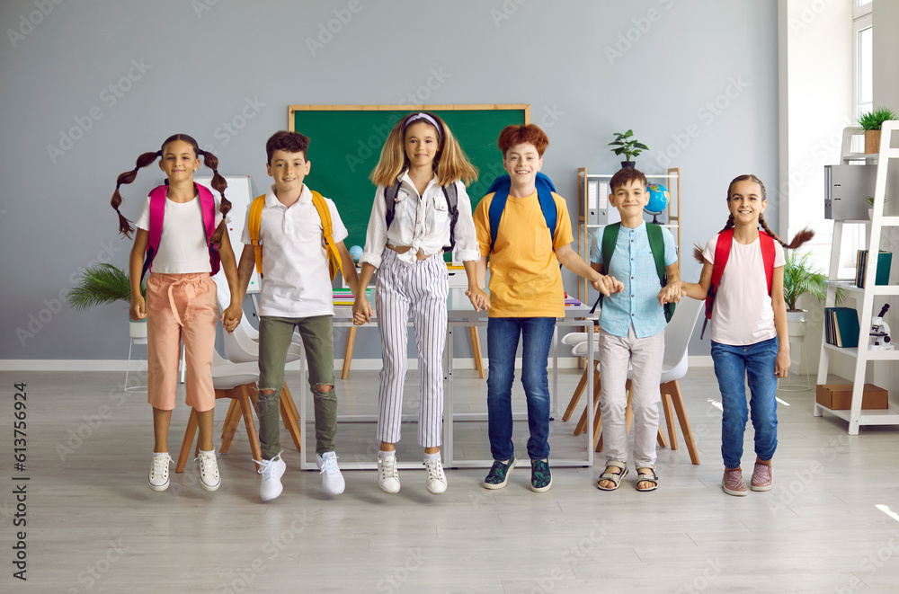 Small group of happy, smiling school-age children in casual clothes and ...