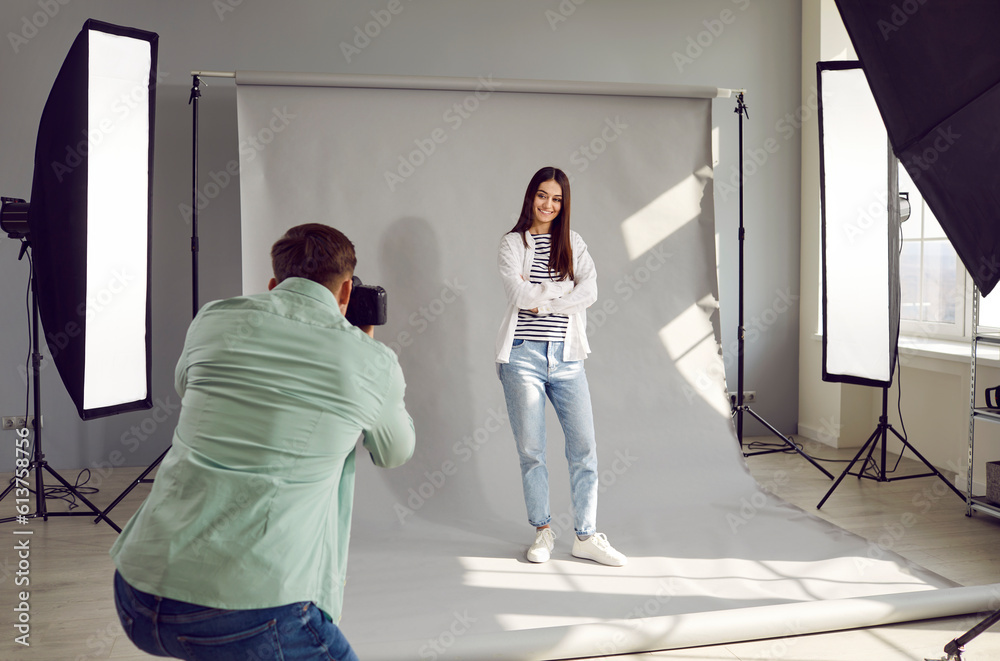 Male photographer shooting model in studio with softboxes and ...
