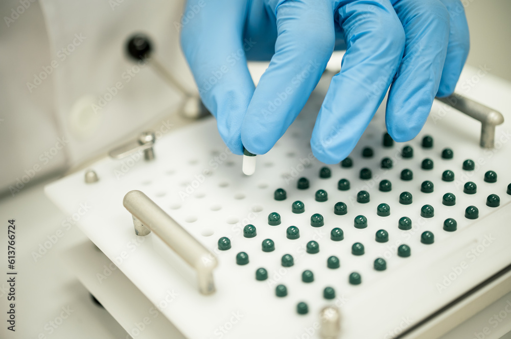 Crop compounding pharmacist putting pill into capsule filler Stock ...