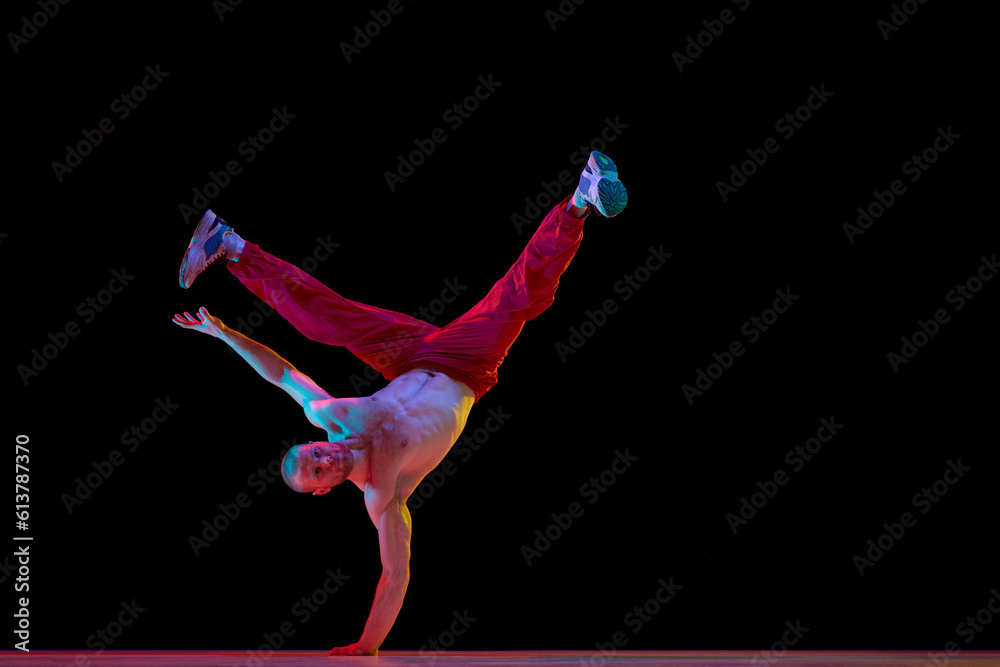 Hand spinning. Muscular, talented, active young man dancing breakdance ...