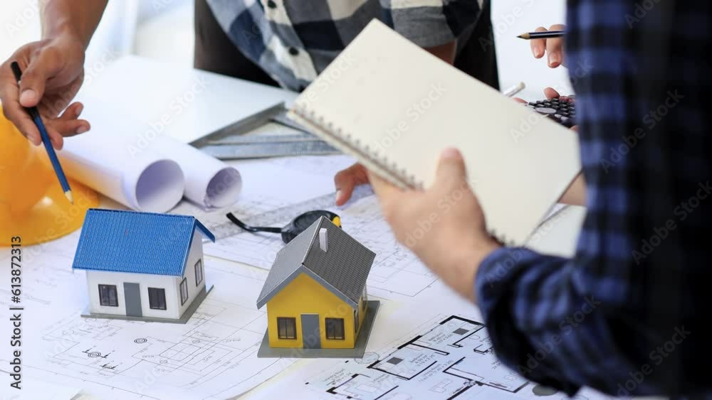 The home design architects are reviewing the house plan draft, the ...