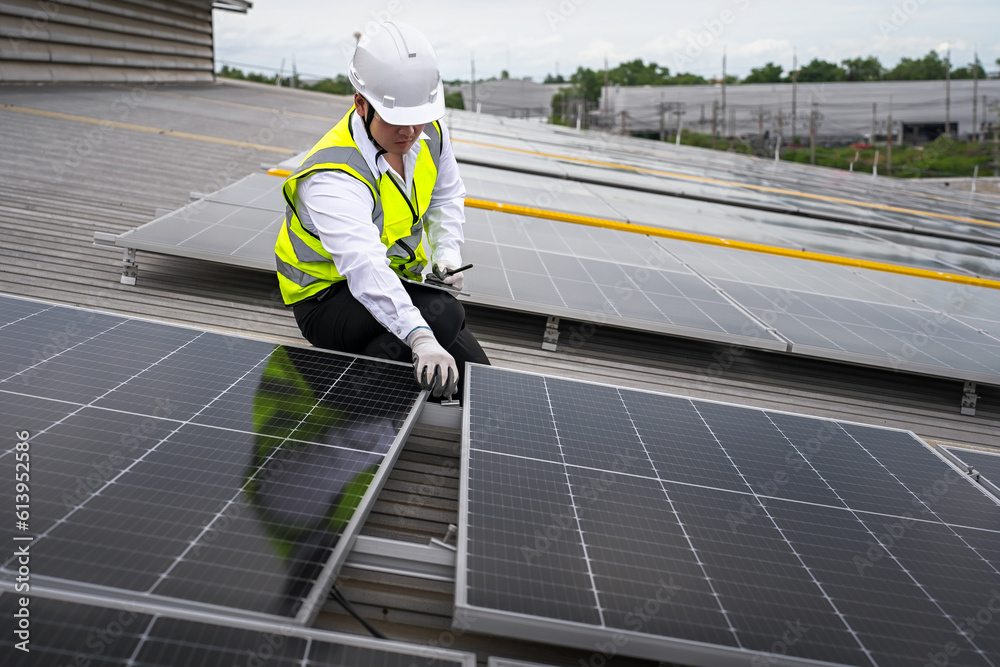 Engineer checking installation of solar panels installed on factory ...