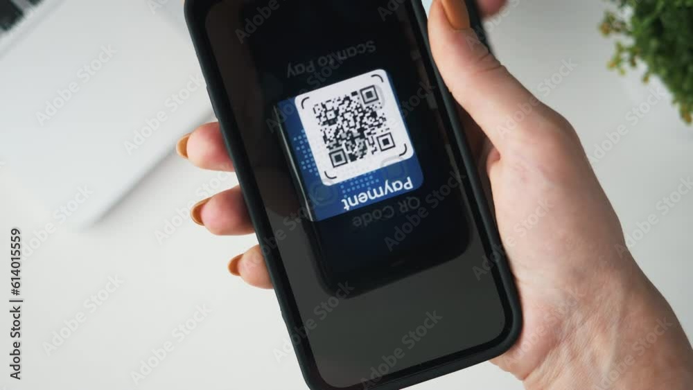 QR code payment. Using a mobile phone to scan a QR code tag and make a ...