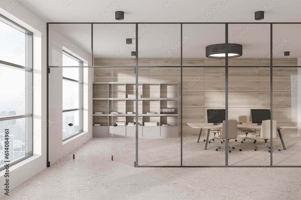 Stylish coworking interior with armchairs and pc computer behind glass ...