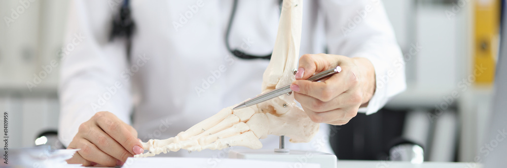 Orthopedic doctor explains physiology of bone model by pointing to ...