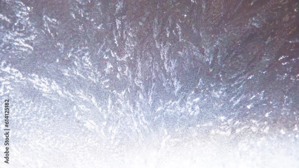 Beam of Light on Frosted Glass. A beam of light glides across a window ...