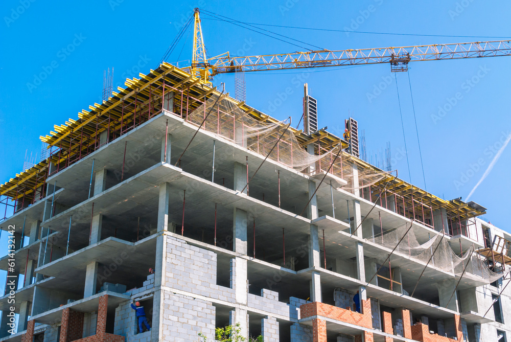 Construction of a multi-storey building. Cladding works on the outside ...