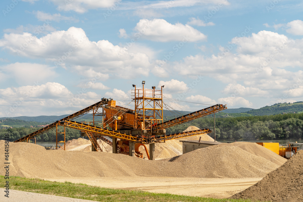 Concrete manufacturing plant and sand piles on the waterfront next to ...