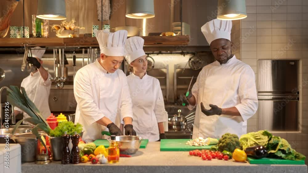 Team of professional chefs cooking vegitables dishes in restaurant ...