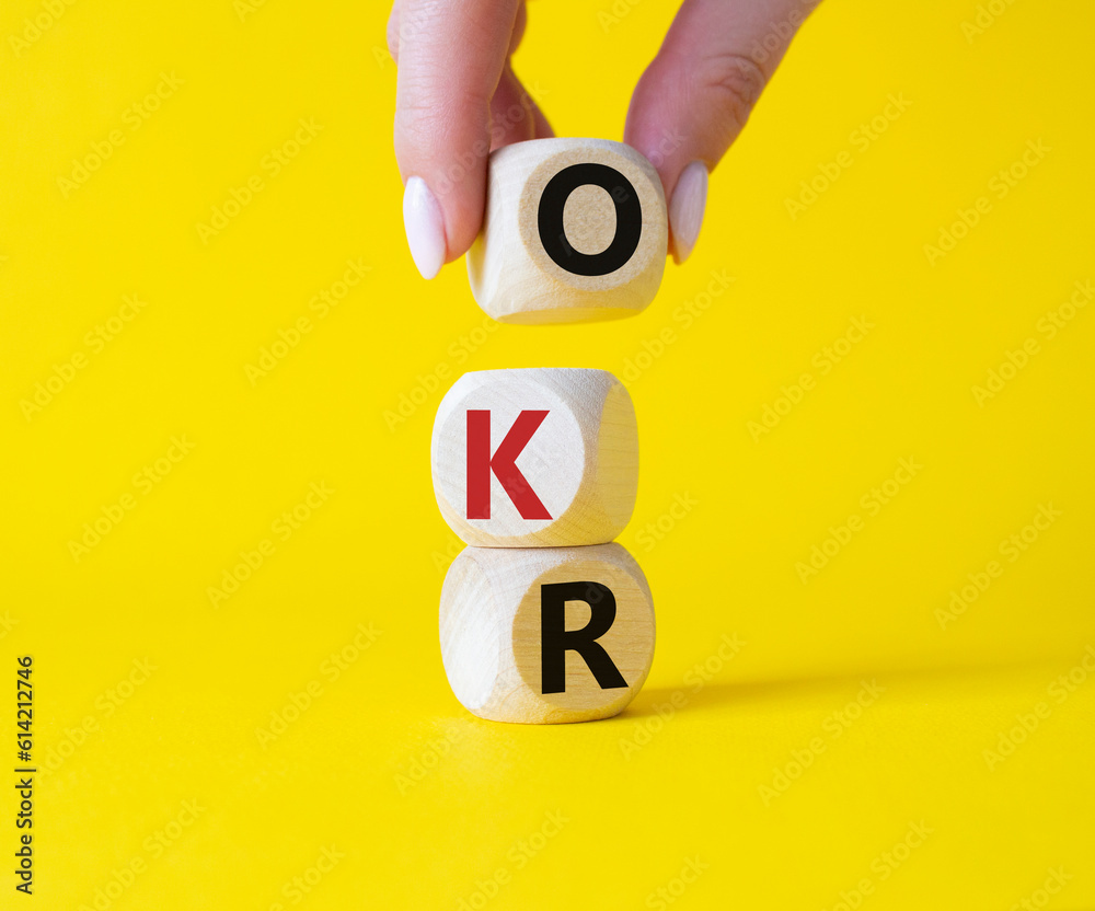 OKR objectives and key results symbol. Wooden cubes with words OKR ...