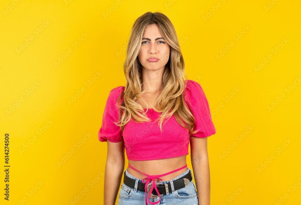 Dismal gloomy rejected Young beautiful blonde woman wearing pink crop ...