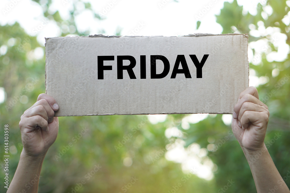 Hands hold word card for teaching with word FRIDAY. Concept, language ...