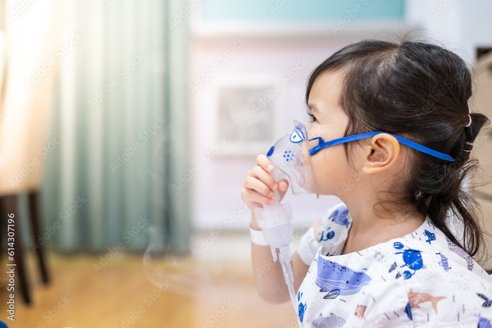 Little asian girl sick making inhalation with nebulizer to reduce ...