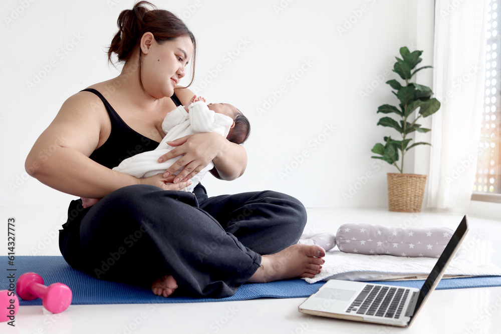 Busy plump mother raising infant newborn baby child while doing ...