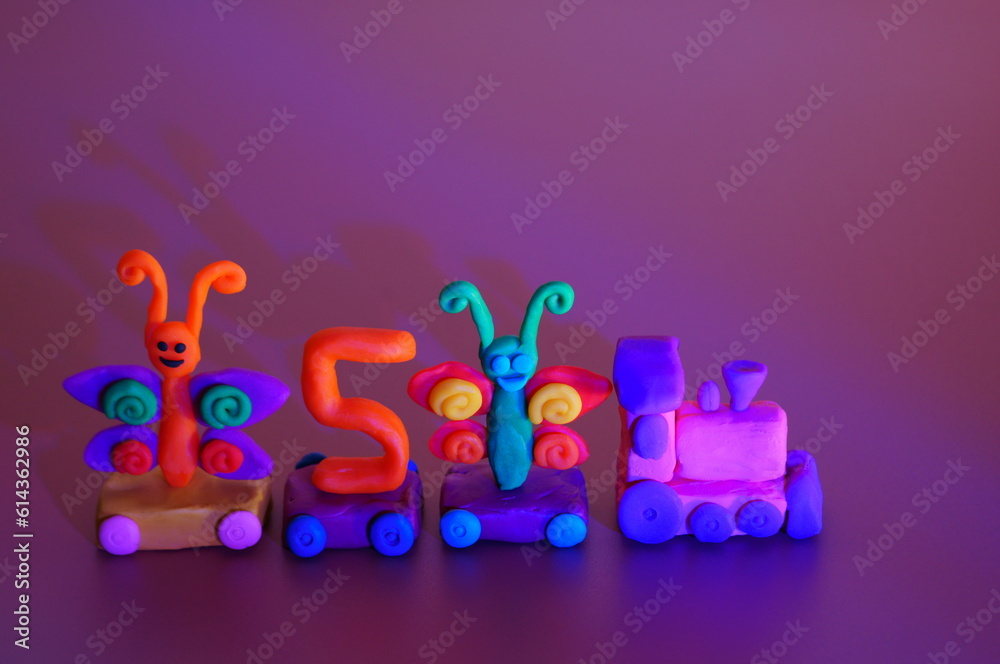 Toy train made of plasticine with butterflies and the number 5 ...