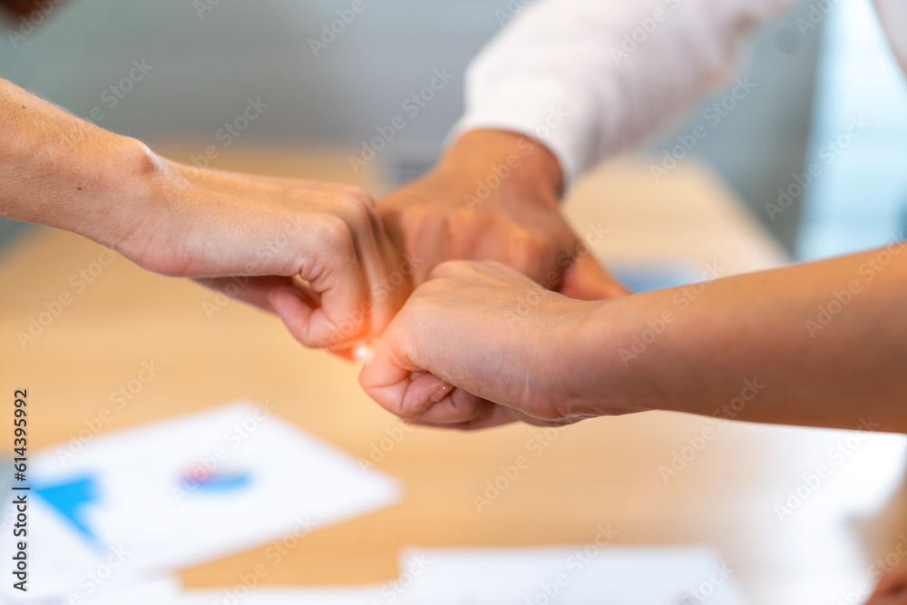 Team of workers complete their work with their hands on each other ...