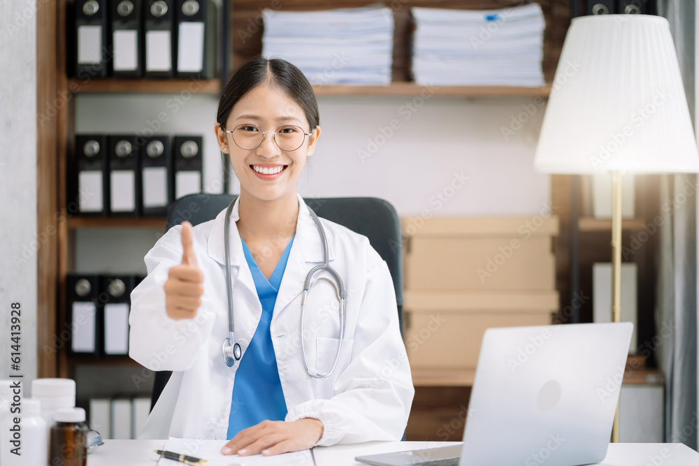 Medical doctor woman giving victory thumbs up to show success and ...