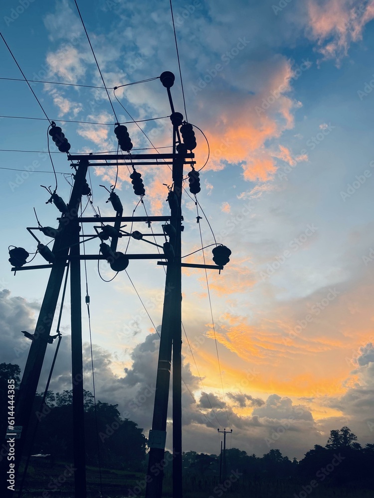 Beautiful sunset with a dramatic sky and overland high voltage lines ...
