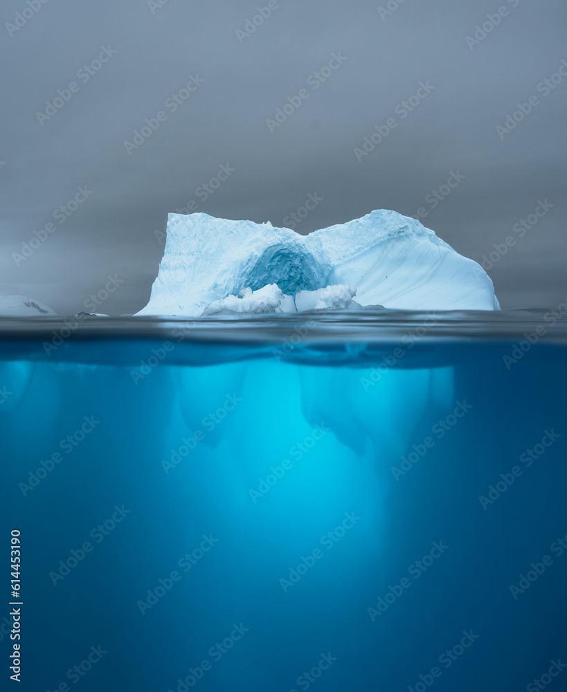 Split view of an iceberg showing above and below the water line ...