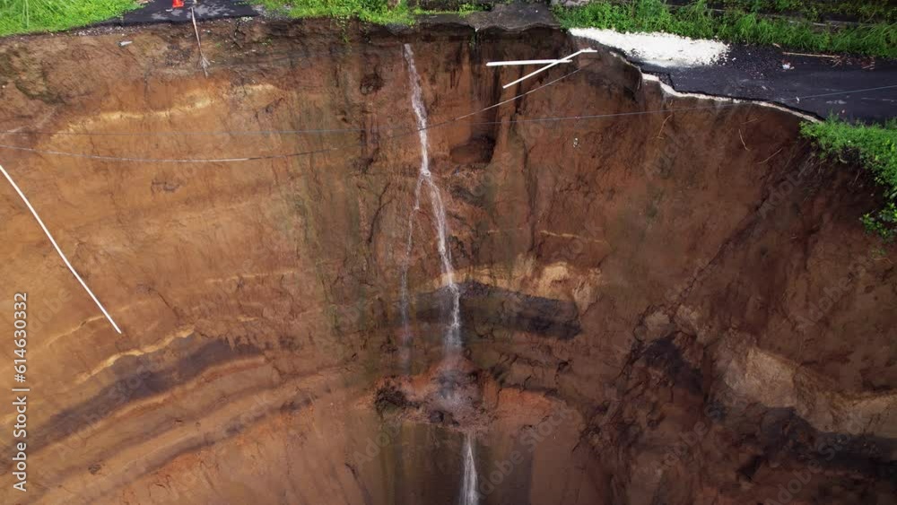 Aftermath of local landslide, water trickles down from broken ...