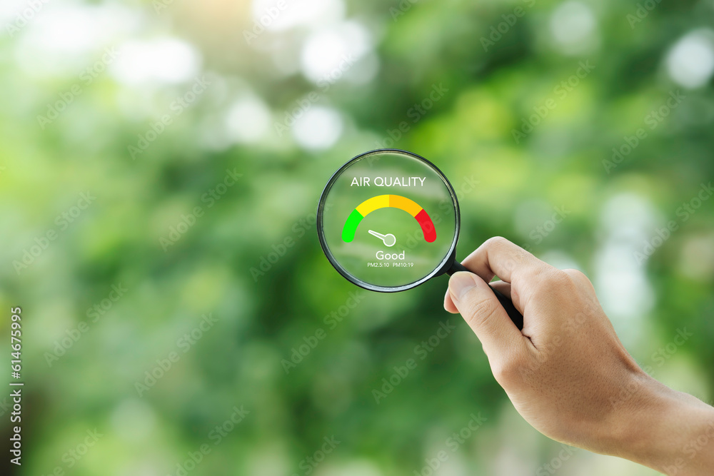hand holding a magnifying glass to check the good air quality and clean ... hand holding a magnifying glass to check the good air quality and clean ...