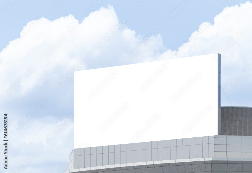 Mock up white large LED display billboard on rooftop building with blue ...