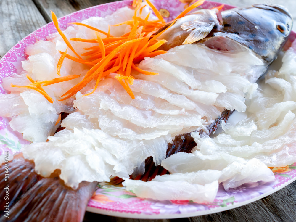 Tasty sashimi. Fresh and clean white fish arranged in the shape of the ...