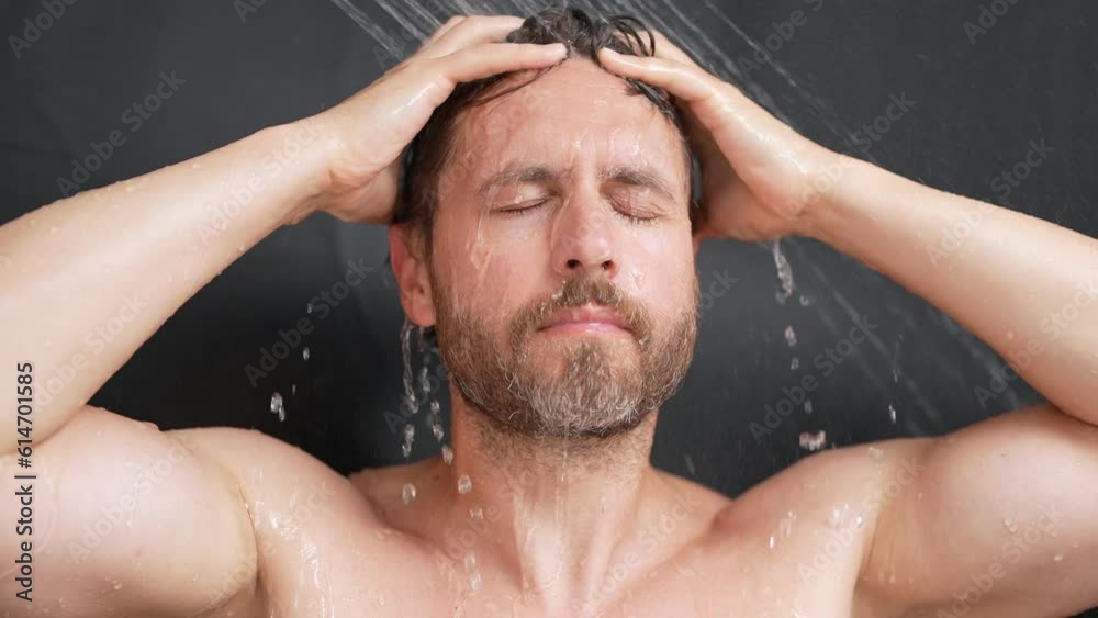 Portrait of man washing hair with shampoo taking shower. Washing hair ...