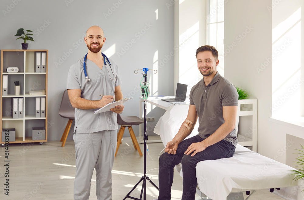 Happy male nurse together with patient. Portrait of young man sitting ...