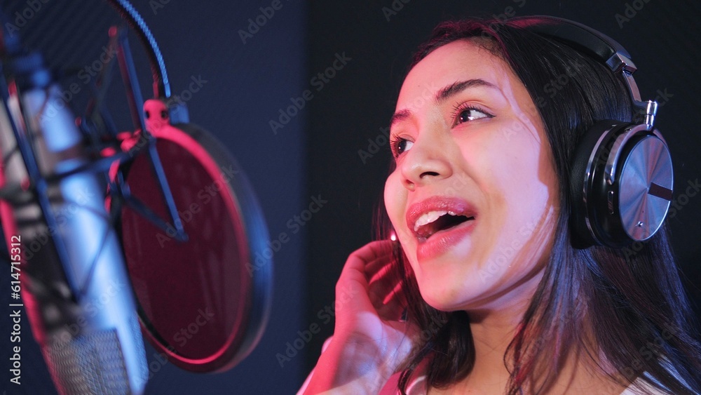 Young asian woman artist singing song at music studio. Woman singer ...