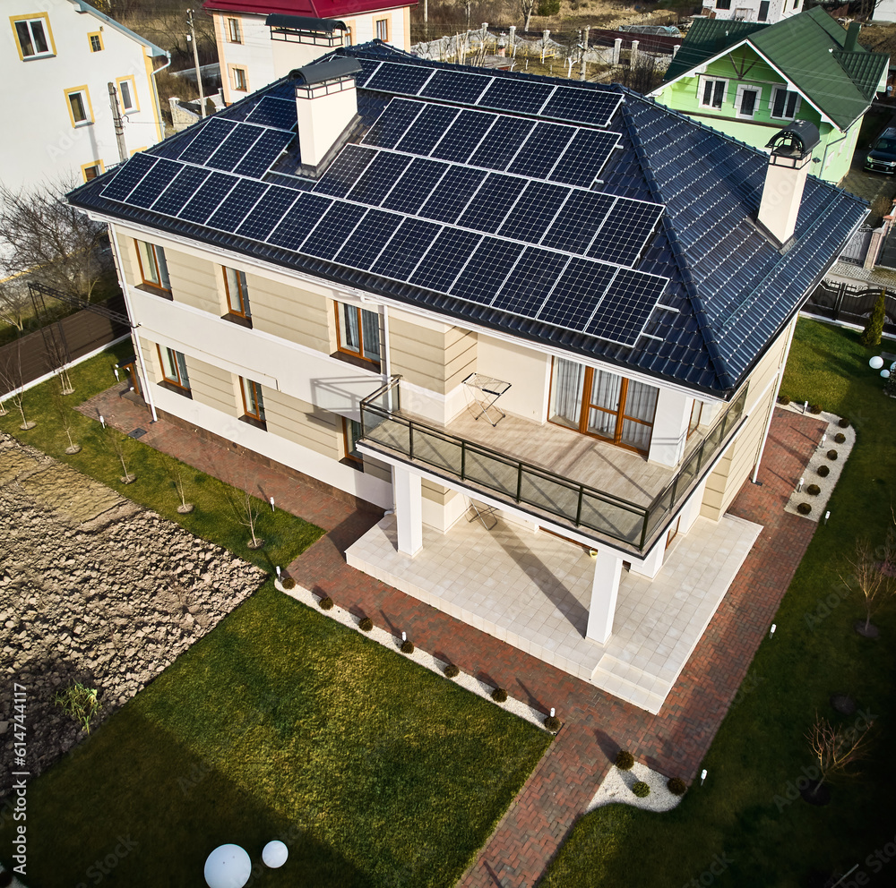 Modern two-storey house with solar panel modules for generating ...