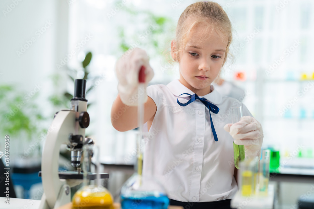 Caucasian cute girl wearing lab coat using dropper and transfer ...