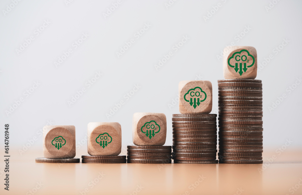 Foto de CO2 reducing icon on increasing coins stacking for decrease CO2 , carbon footprint and ...