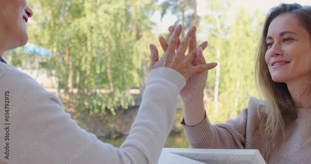 Feel the deep connection of human touch as the hands of a female couple ...