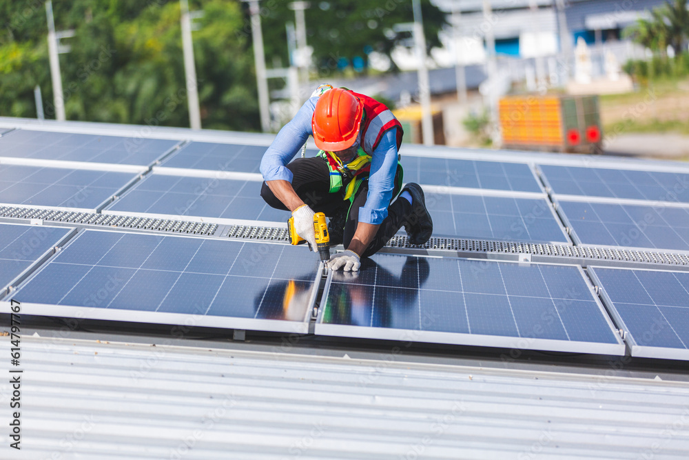 Professional technicians carrying photovoltaic solar moduls on factory ...