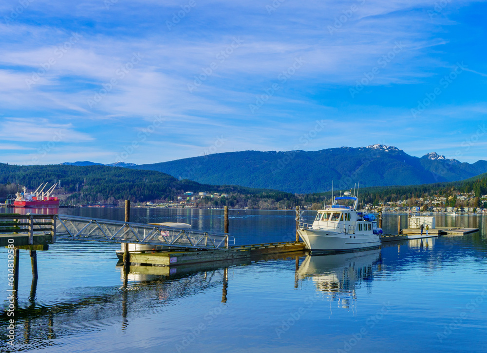 Boat by jetty on pristine waters of Burrard Inlet at Rocky Point Park ...