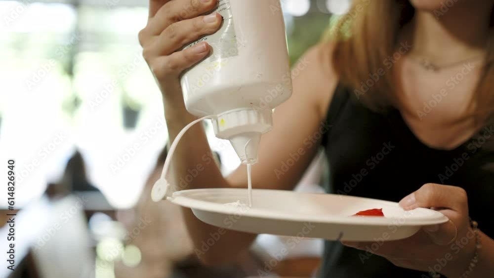 Close-up young woman's hand holding watercolor flask, was using hand ...