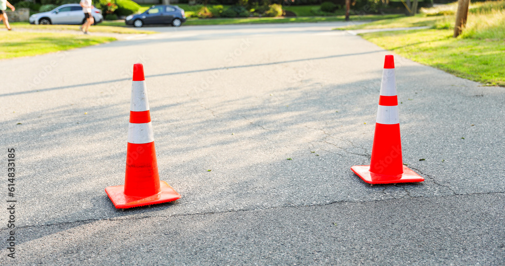 right orange construction cones line the street, symbolizing progress ...