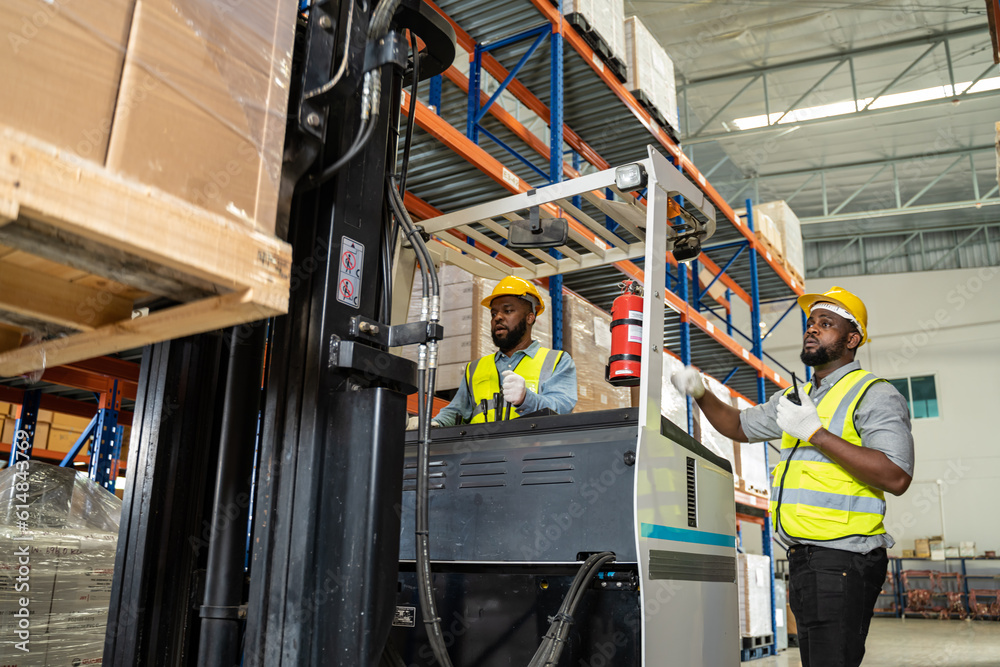 Two African workers working in a warehouse Organized the product system ...