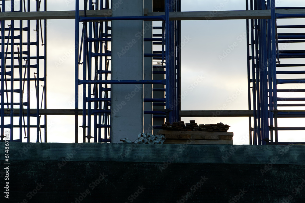 silhouette of building concrete structures with rebar against the ...