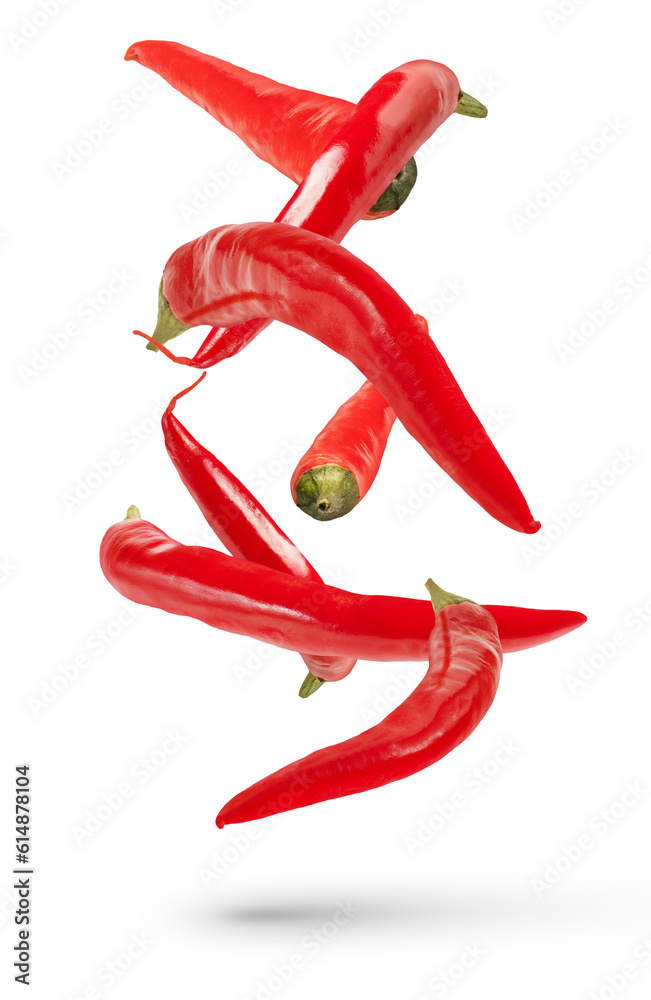 Pods of red hot peppers of various sizes and shapes fall on a white ...
