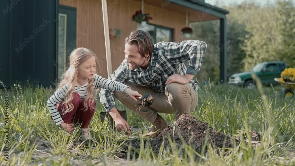 Handsome father communicating with his lovely doughter in garden ...