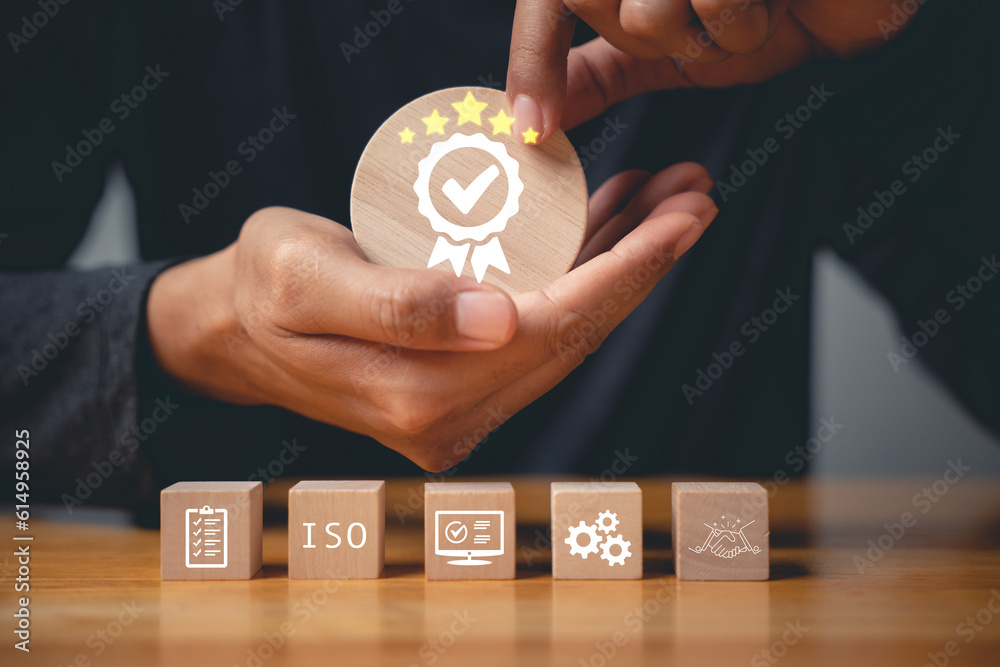 The ISO standards and certification concept is depicted by a hand ...