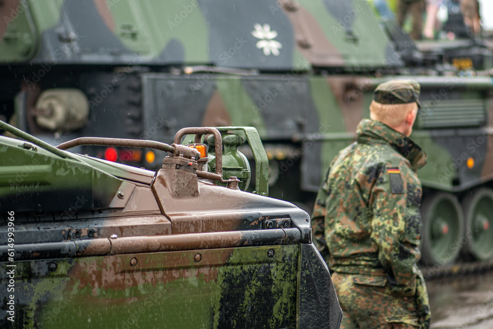 German soldier walking near moving armoured tanks self-propelled ...