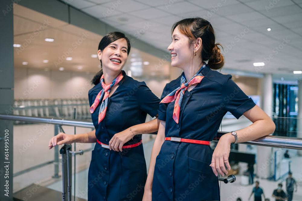 Two beautiful asian woman working in flight attendants in uniform ...