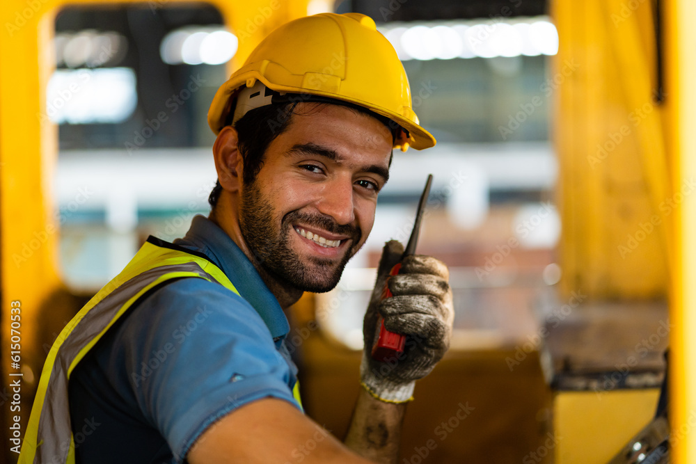 A handsome train driver uses a walkie-talkie or walkie-talkie in the ...