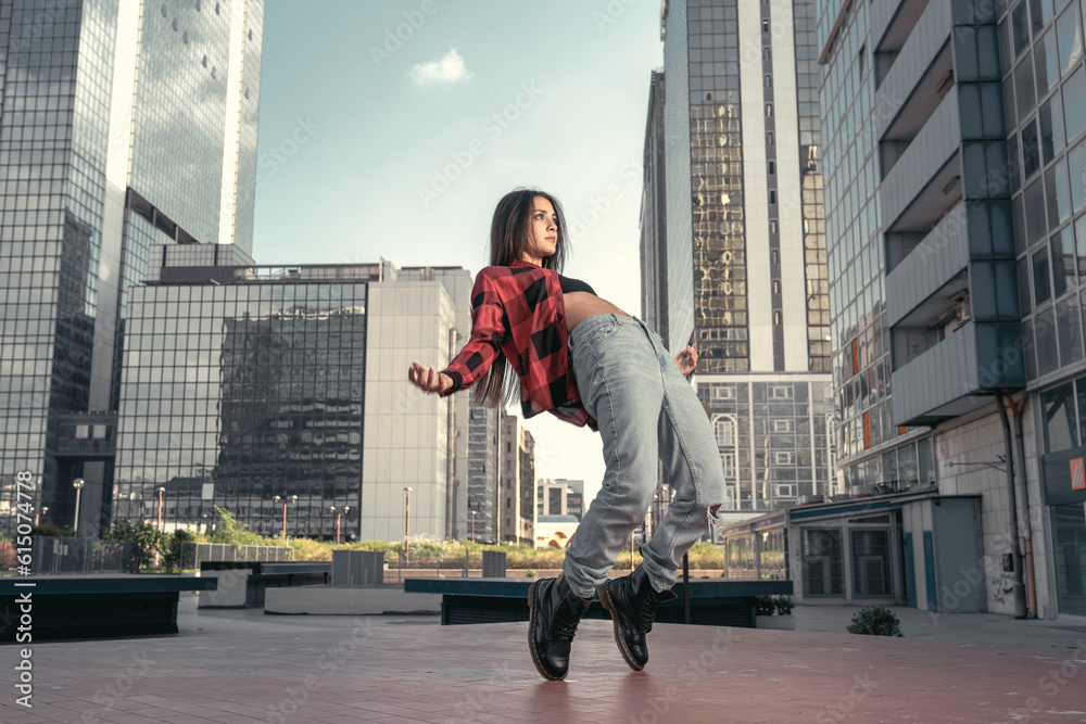 Photo shoot of stylish caucasian hip hop dancer posing on her toes with ...