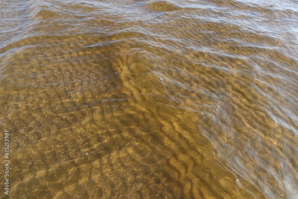 Beautiful background with transparent water and ripples on sandy bottom ...